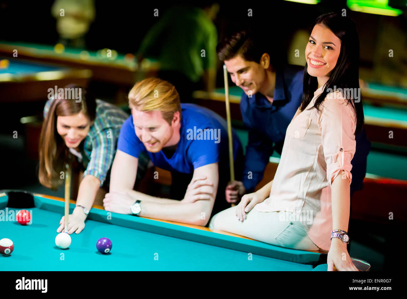 Young people playing pool Stock Photo - Alamy