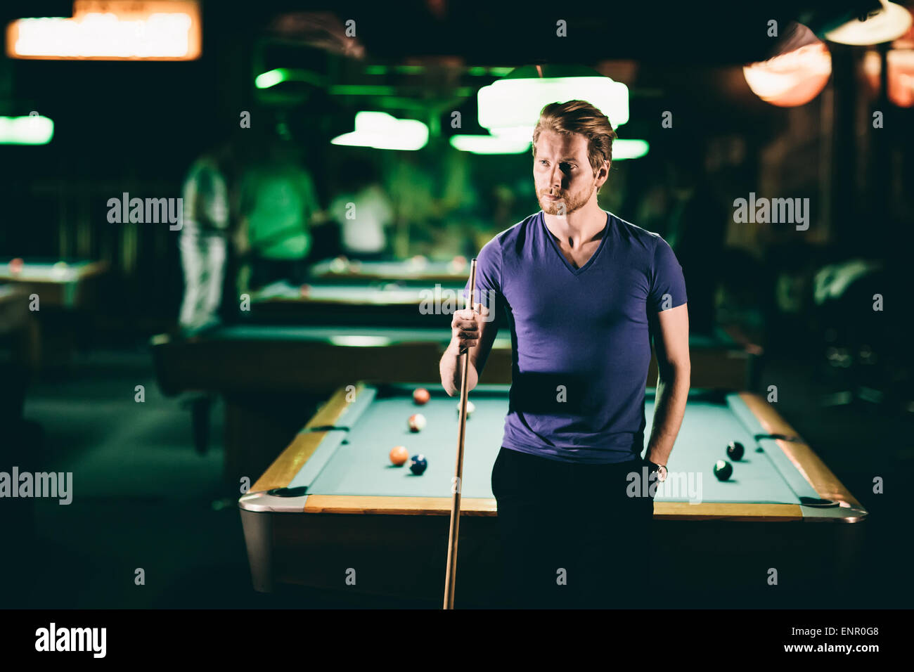 Young man playing pool Stock Photo - Alamy
