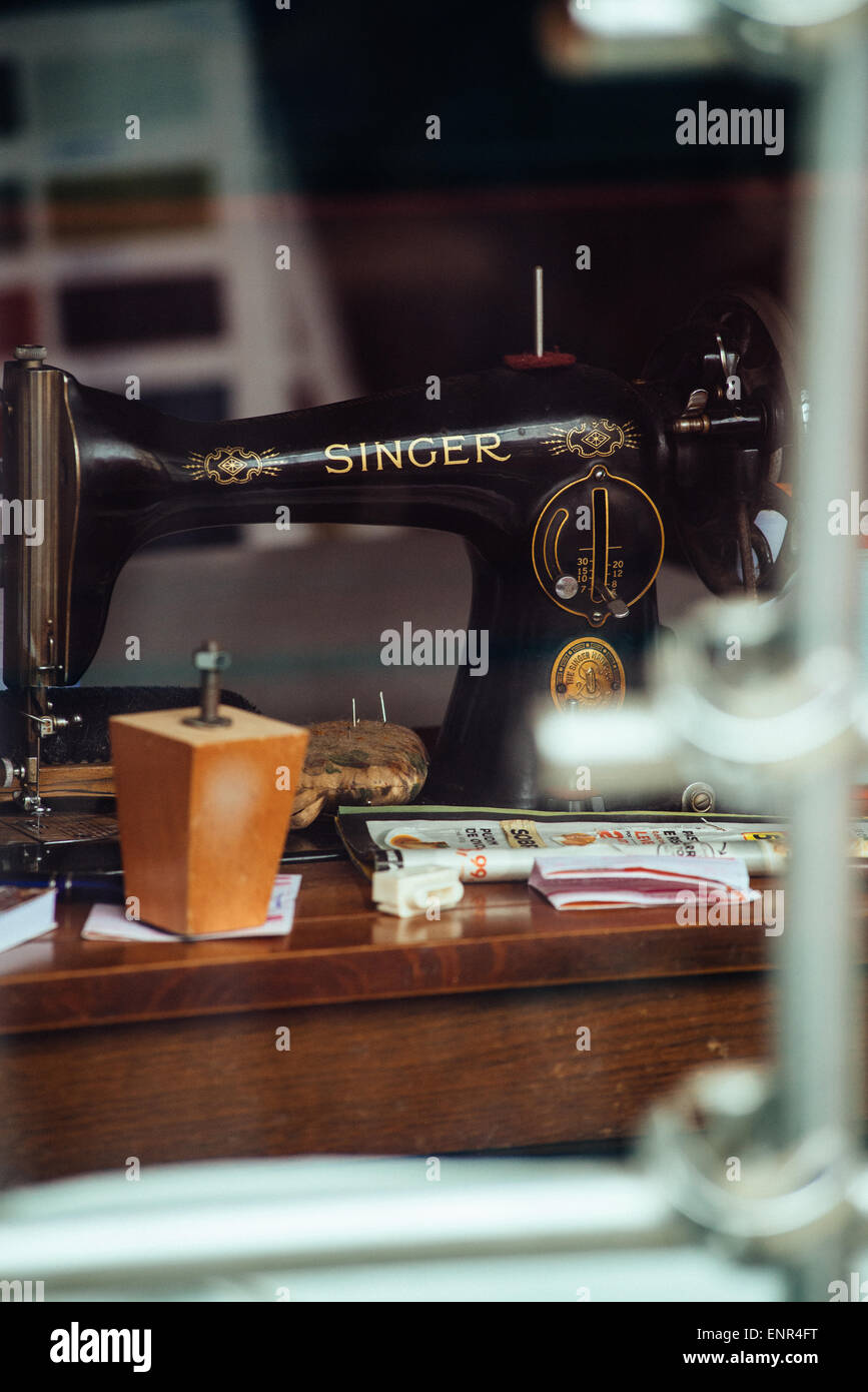 Singer sewing machine in the window of sewing workshop Stock Photo - Alamy