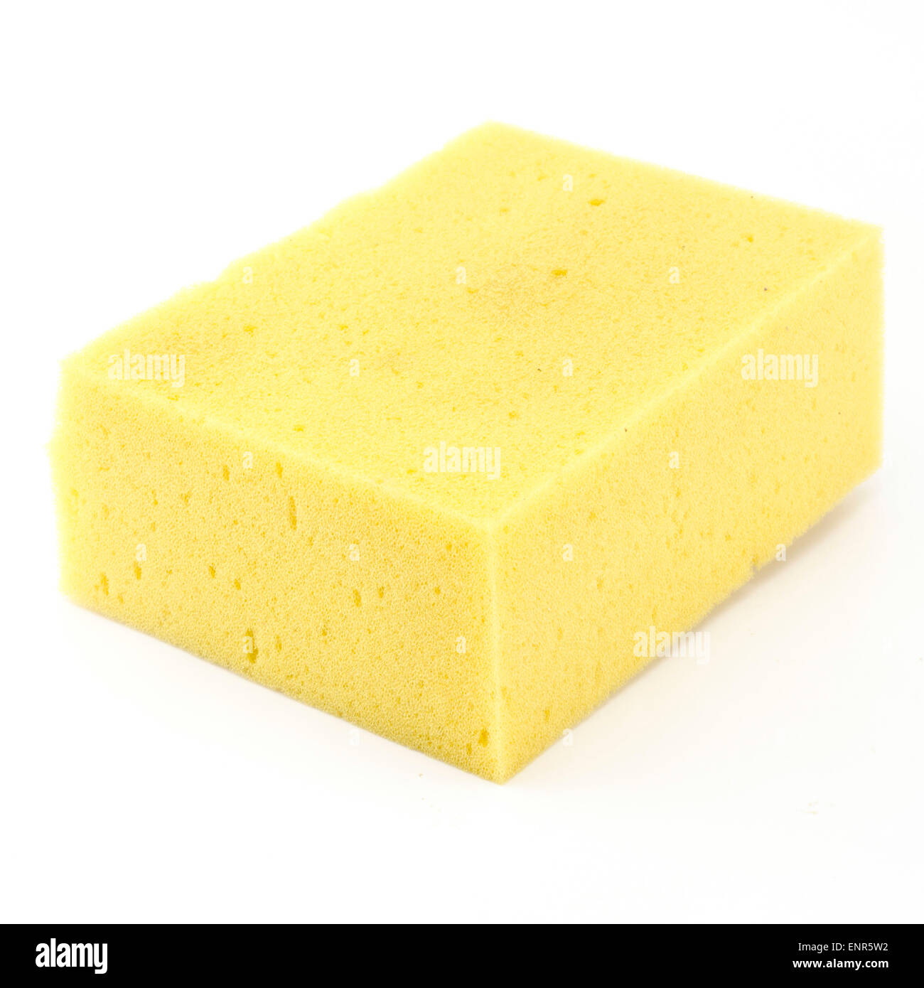 yellow household sponge isolated on white background Stock Photo - Alamy