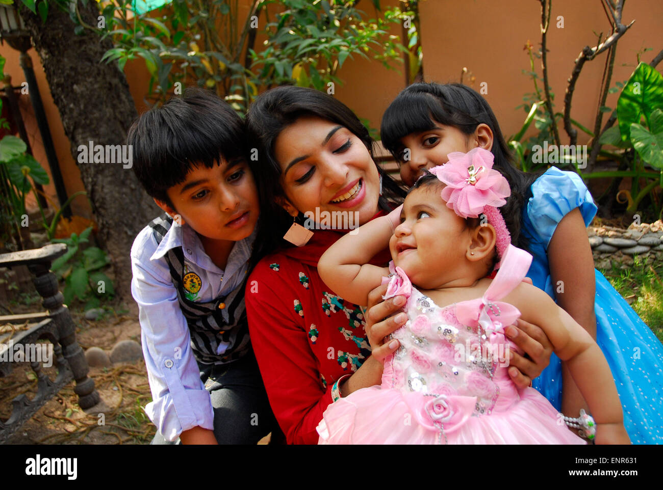 Islamabad. 10th May, 2015. A Pakistani mother plays with her children ...