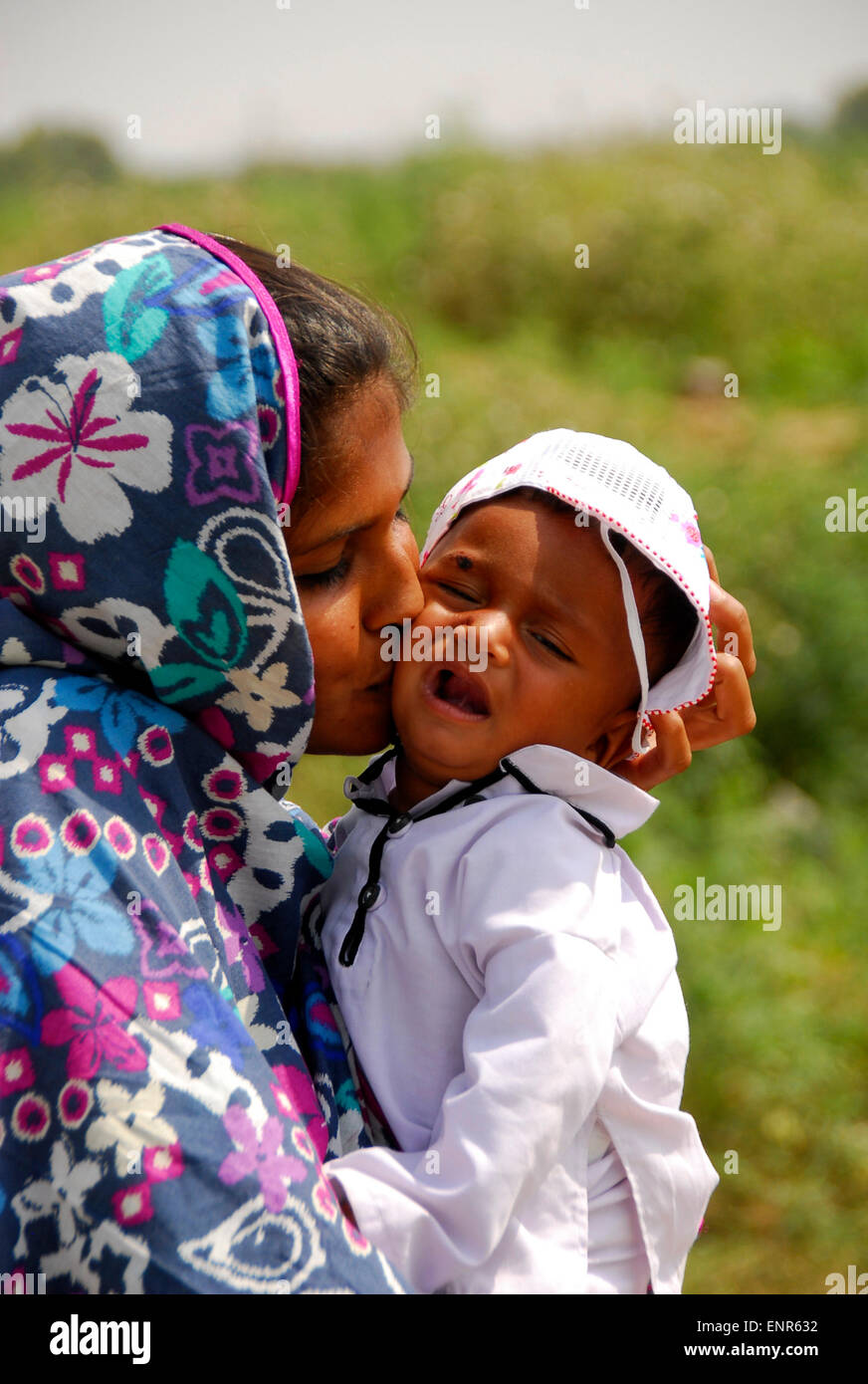 Islamabad. 10th May, 2015. A Pakistani mother kisses her child in ...