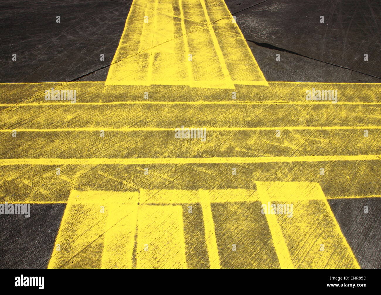 Pattern with grunge yellow cross painted on asphalt Stock Photo - Alamy