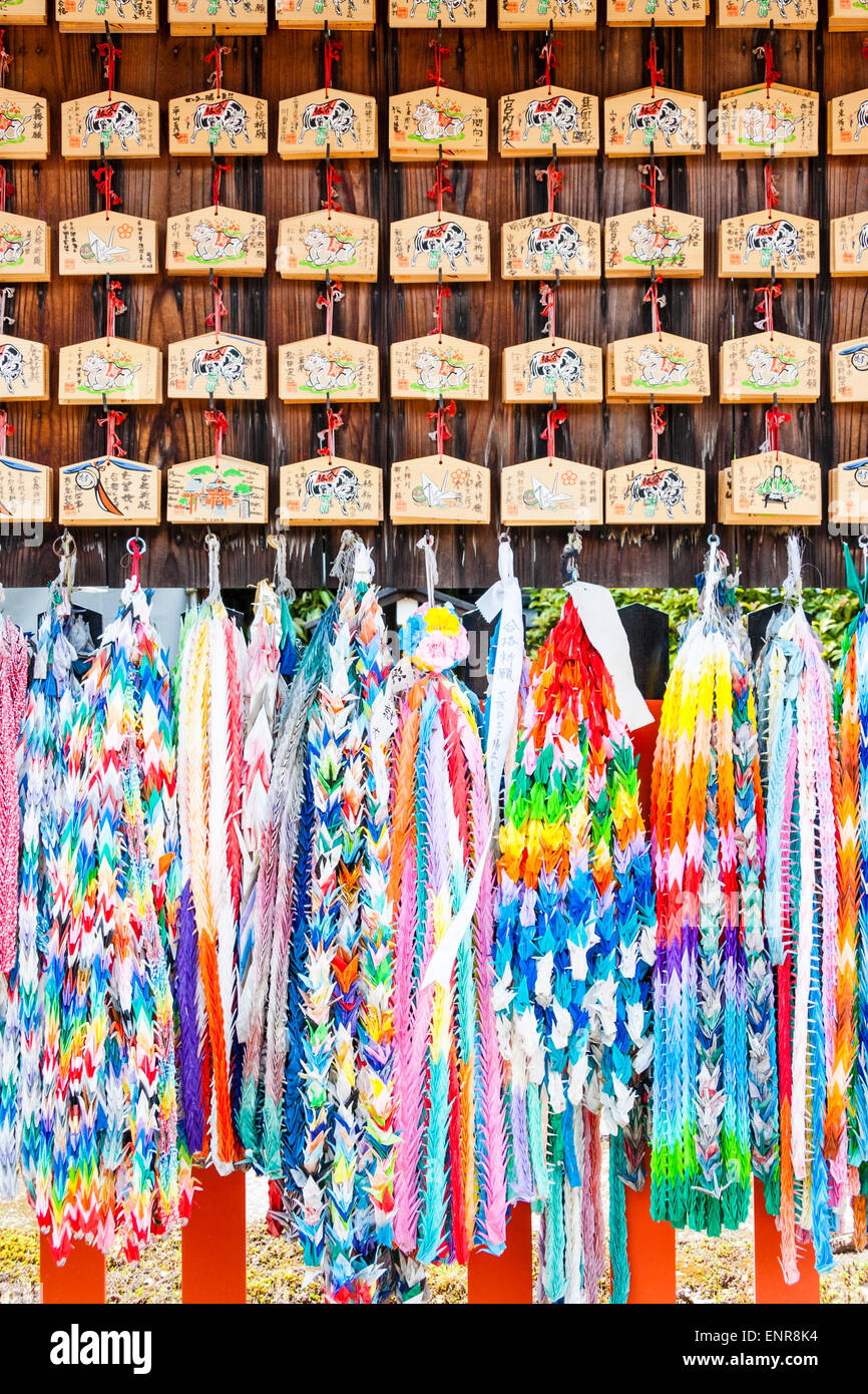Rows of Ema boards, or wishing tablets, hanging from a board with ...