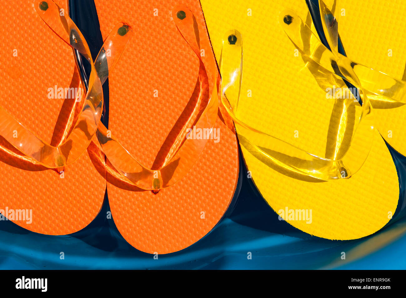 Multicolored flip flops floating in small pool Stock Photo - Alamy
