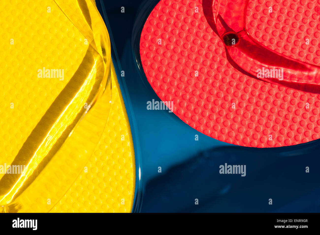 Multicolored flip flops floating in small pool Stock Photo - Alamy