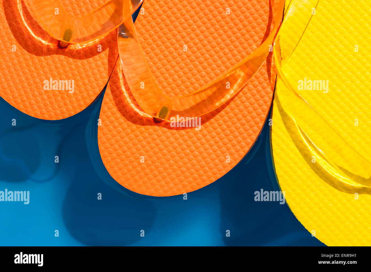 Multicolored flip flops floating in small pool Stock Photo - Alamy