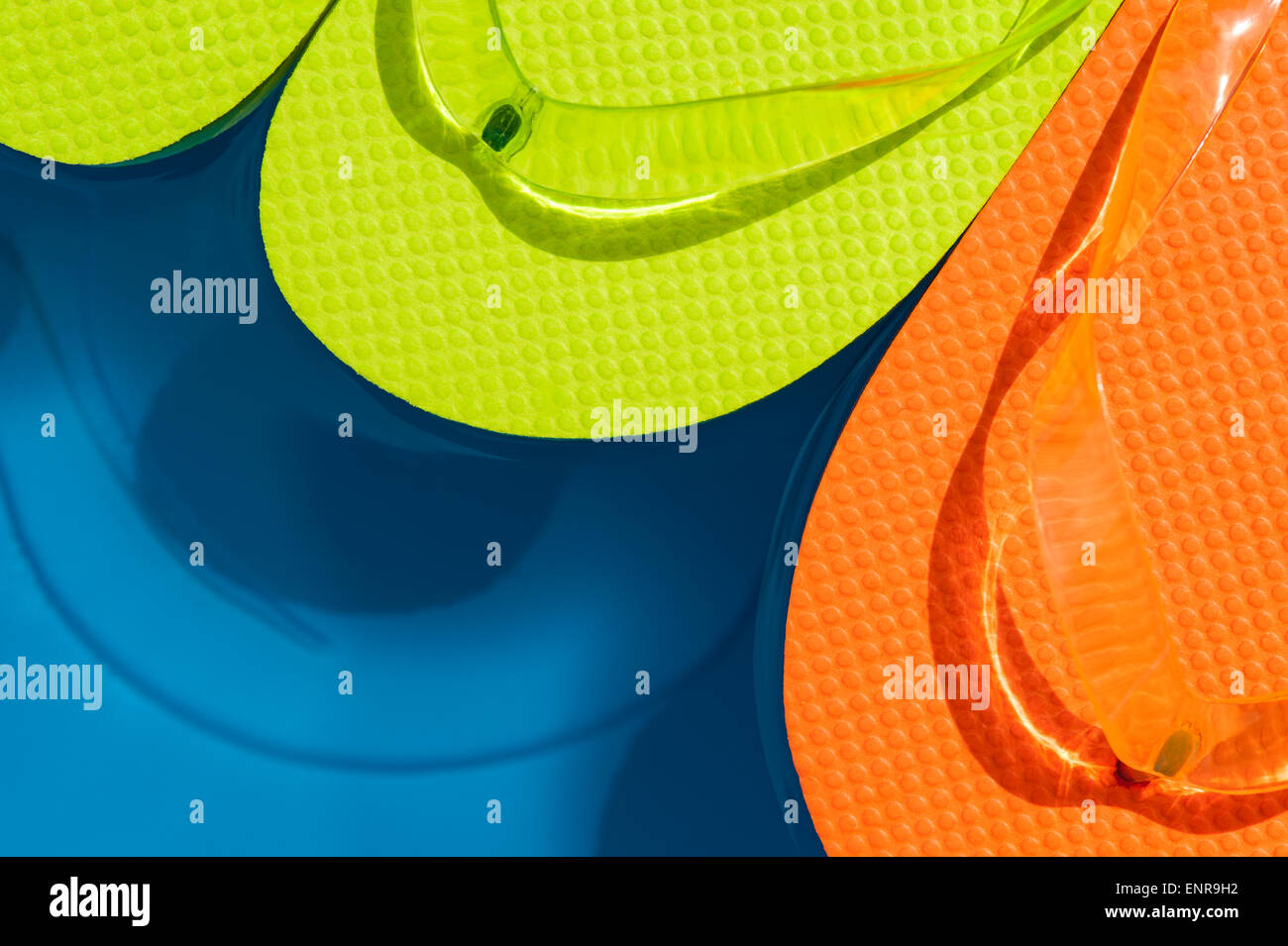 Multicolored flip flops floating in small pool Stock Photo - Alamy