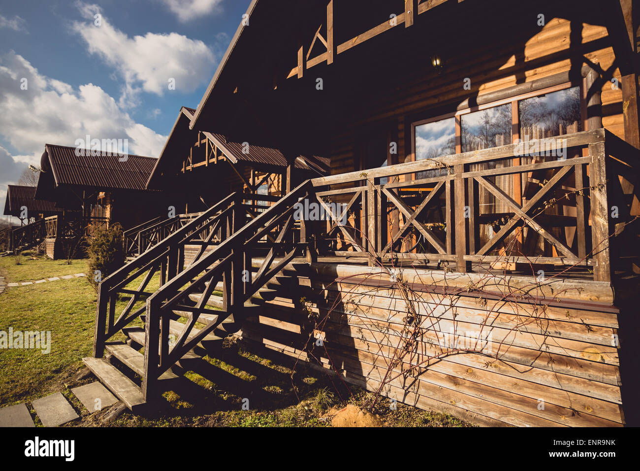 Toned photo of traditional wooden cottage with big terrace Stock Photo ...