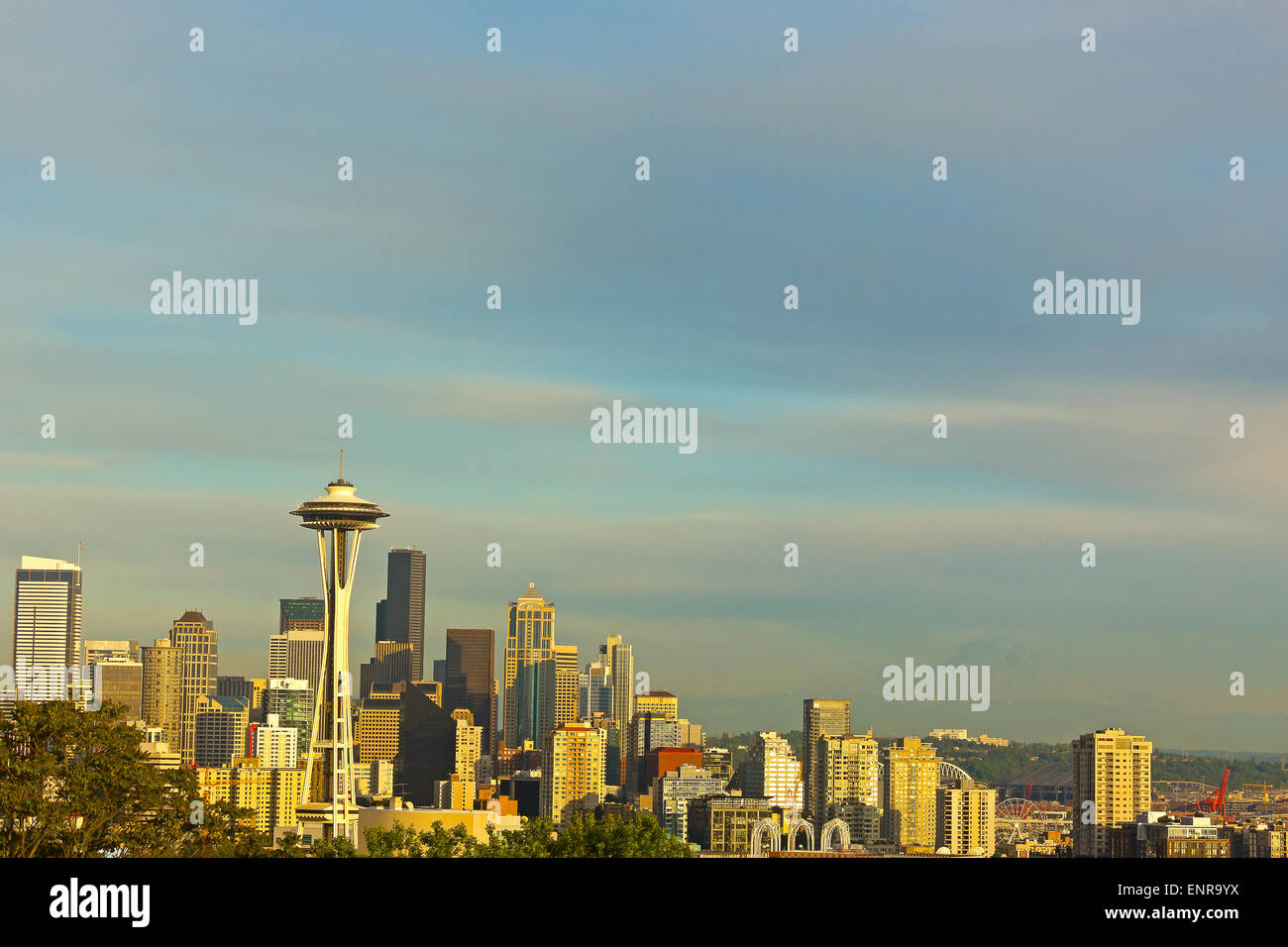 Illuminated Seattle skyscrapers and contour of Mount Rainier at sunset ...