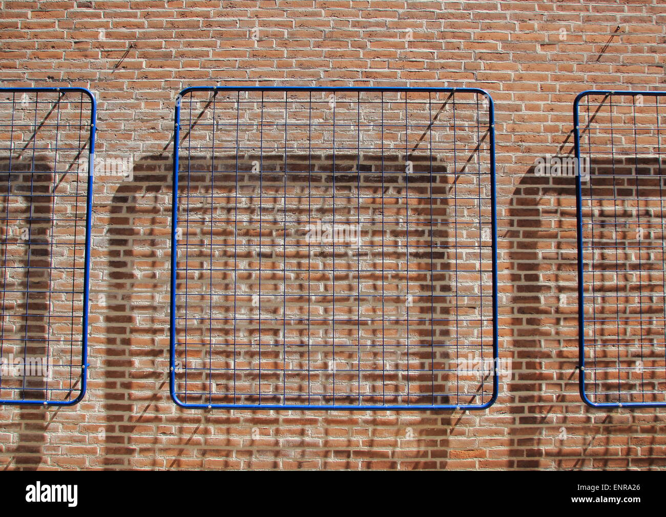 Blue net on brick wall with shadow background Stock Photo - Alamy