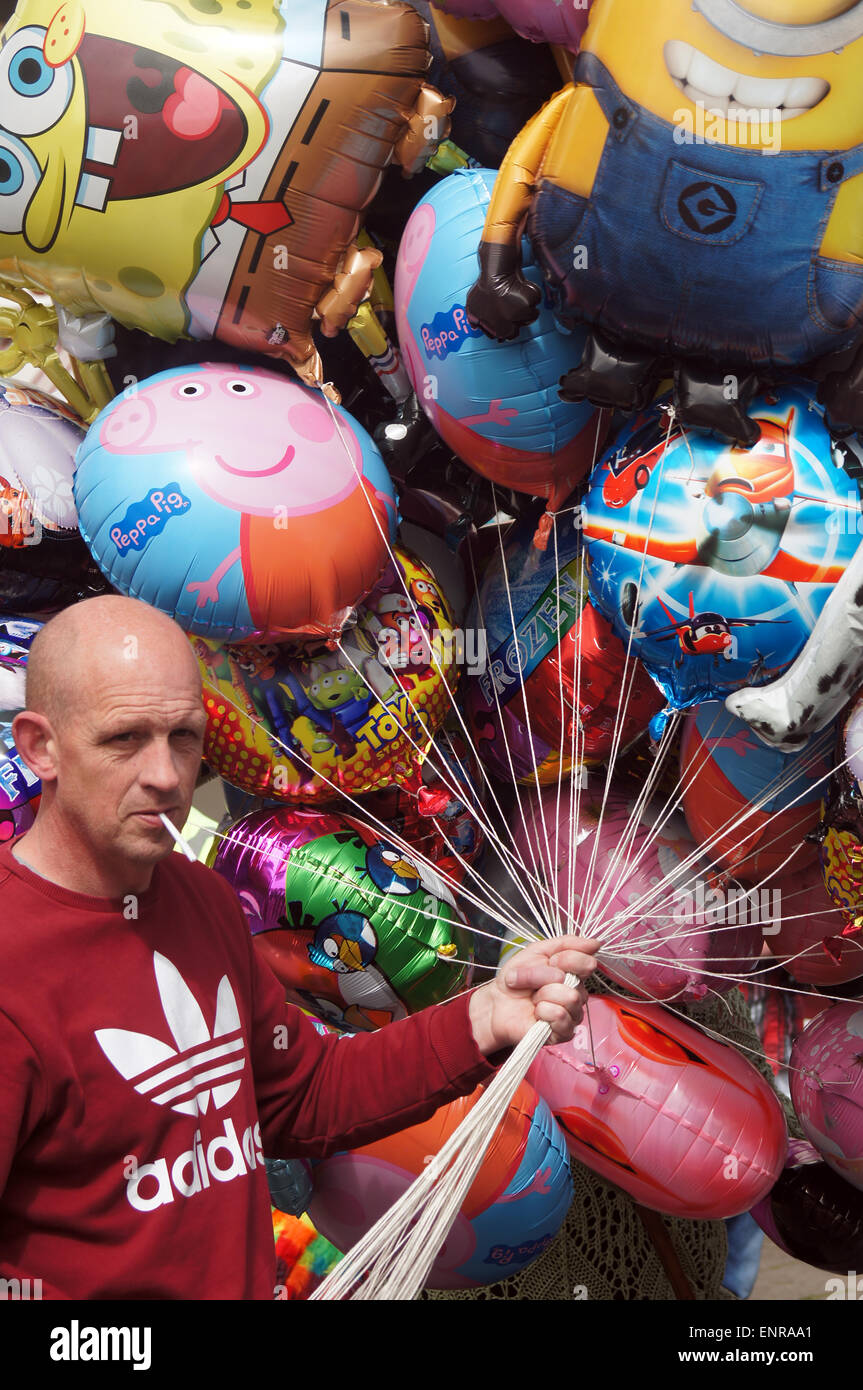 Balloon seller holding colorful balloons Stock Photo - Alamy
