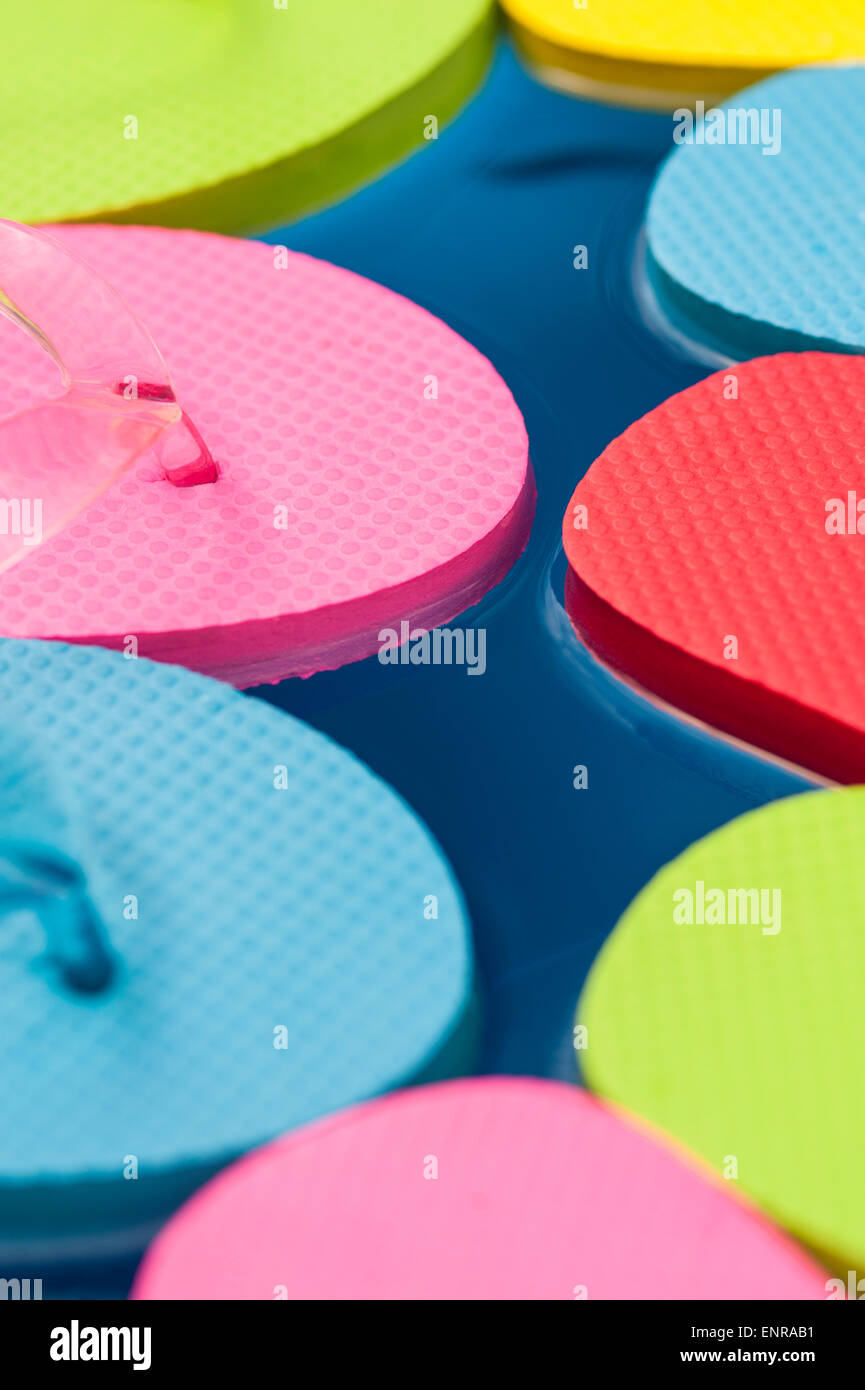 Multicolored flip flops floating in small pool Stock Photo - Alamy