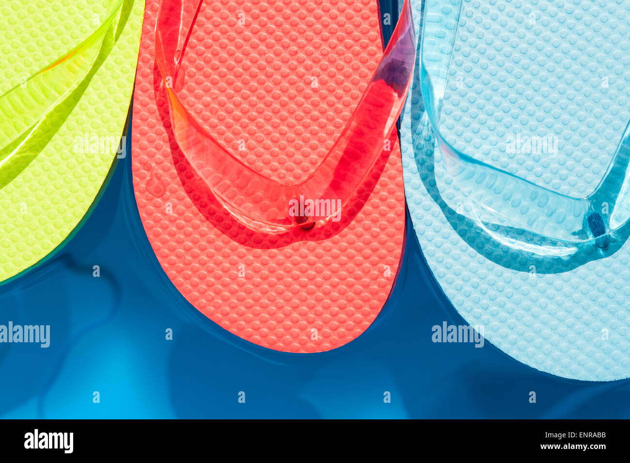 Multicolored flip flops floating in small pool Stock Photo - Alamy