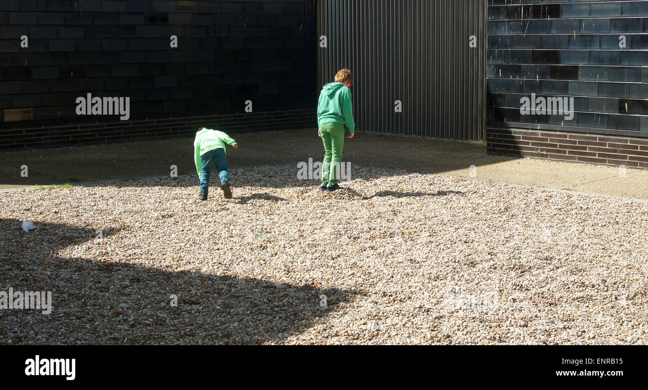 Children play with pebbles Stock Photo - Alamy