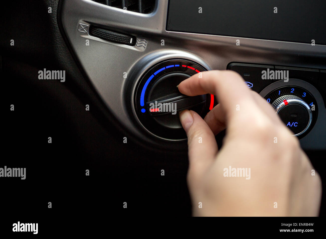 Closeup photo of young woman turning car air conditioner switch Stock ...