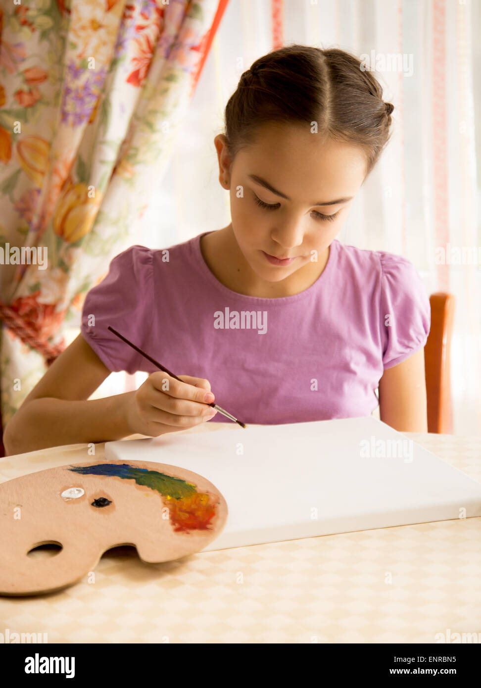 Portrait of concentrated girl drawing on canvas by oil paints Stock ...