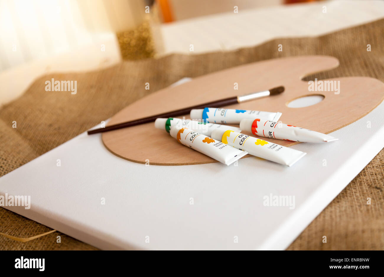 Oil paint tubes, pallet and brush lying on table at living room Stock ...