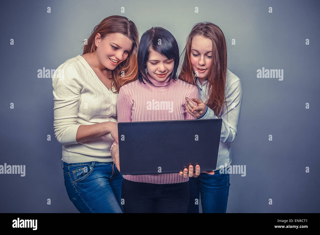 Three girls European appearance girlfriend looking at computer screen ...