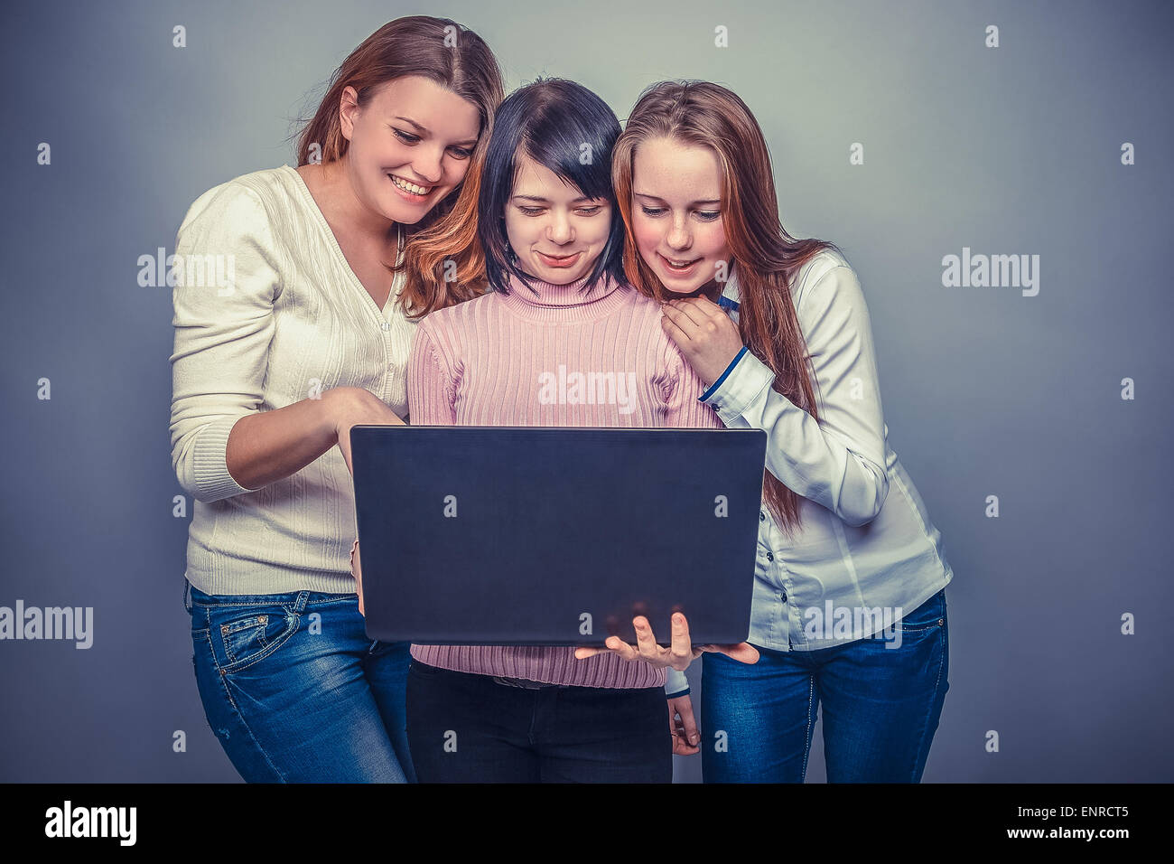 Three girls European appearance girlfriend looking at computer screen ...