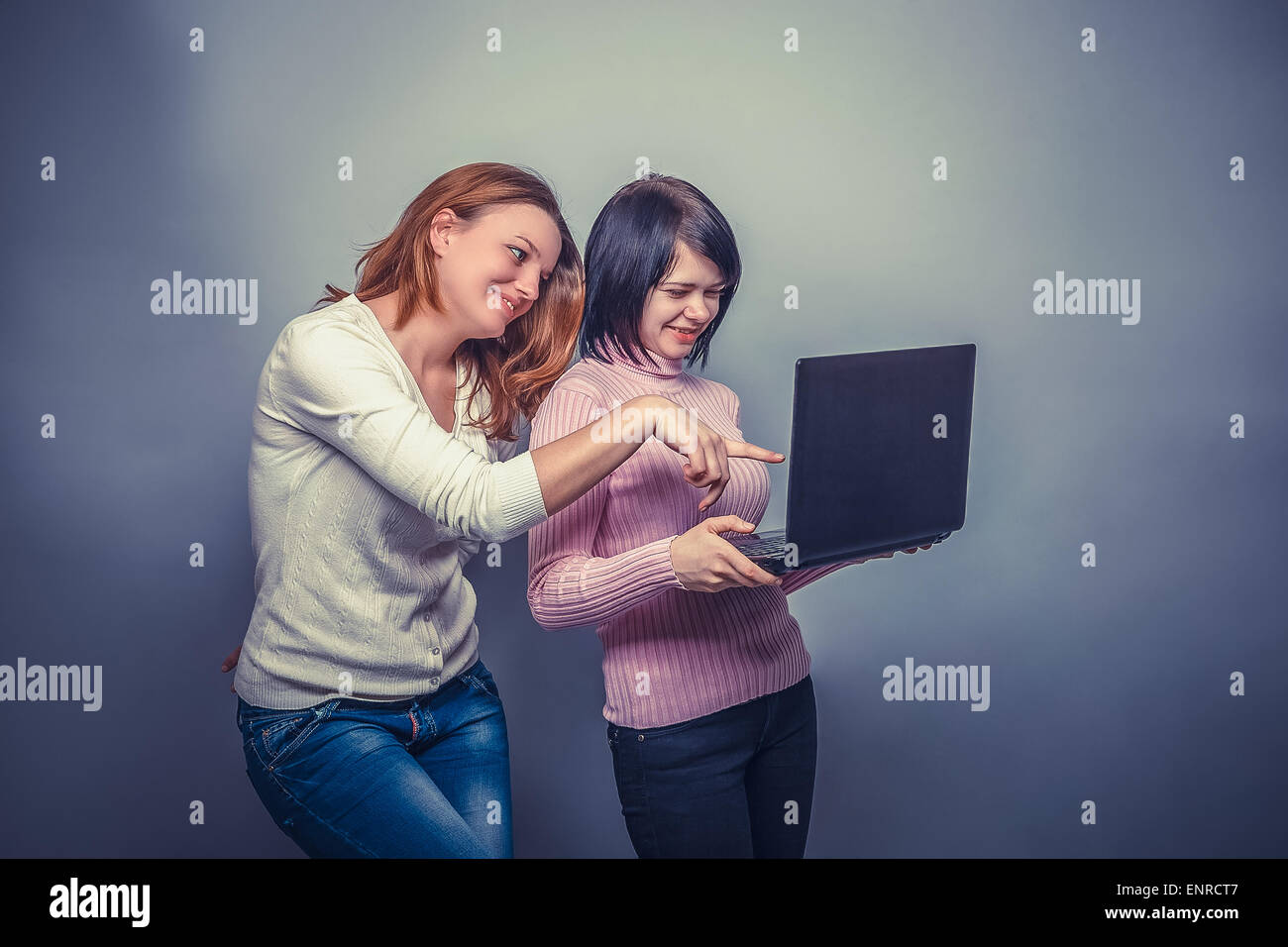 Three girls European appearance girlfriend looking at a computer screen ...