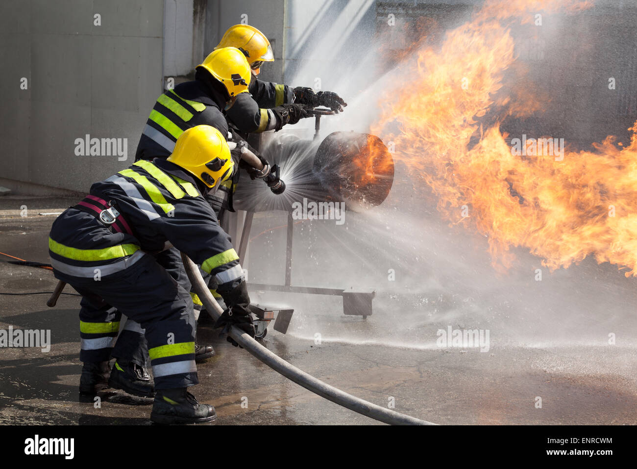 firefighters attack a propane fire during a training exercise Stock ...