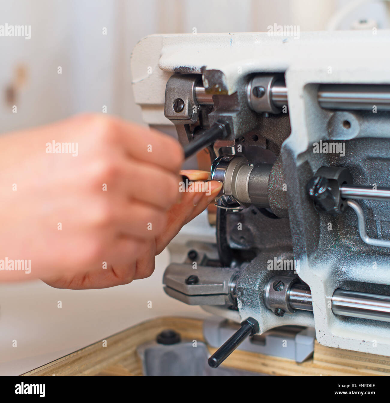 Female hand fixing sewing machine. Maintenance Stock Photo - Alamy