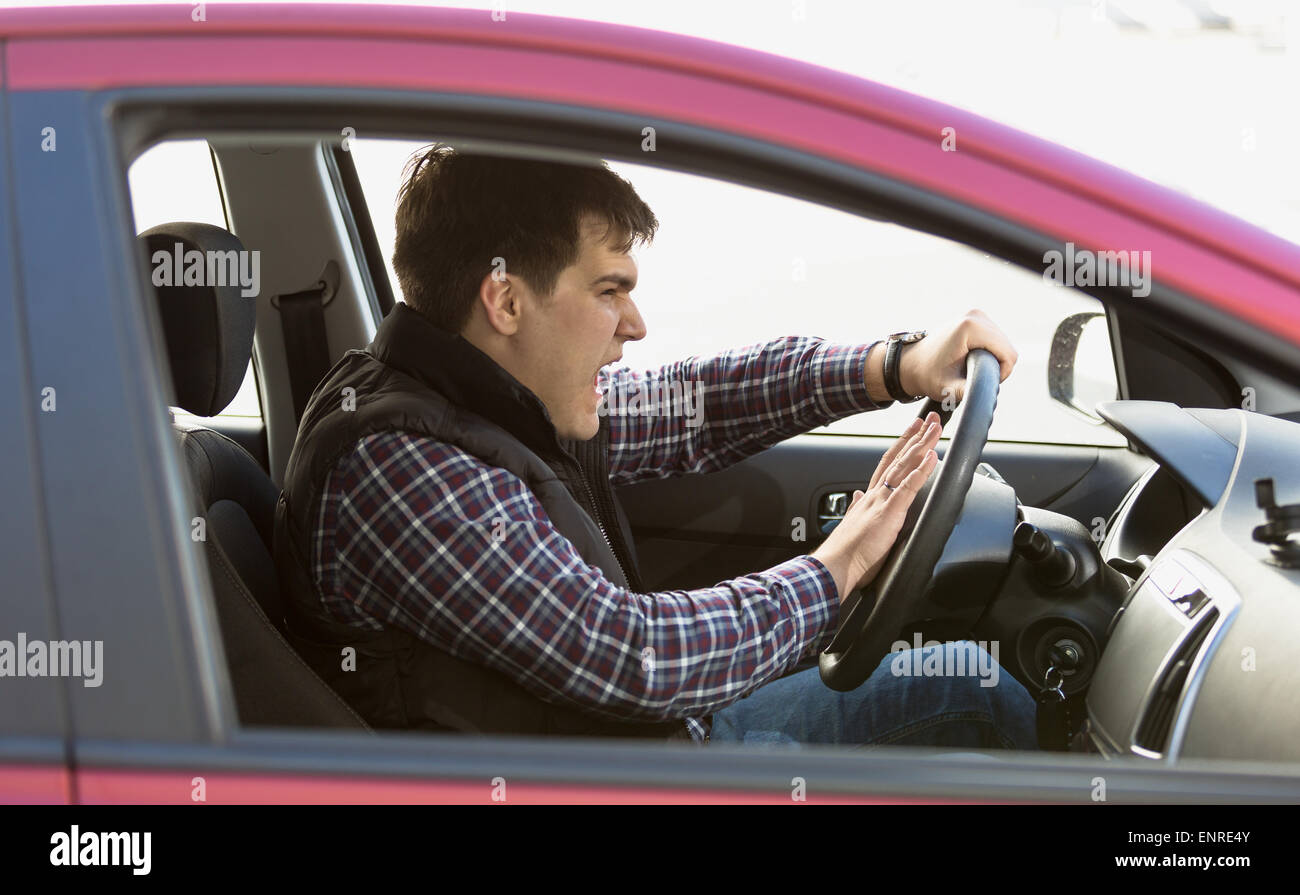 Closeup portrait of aggressive male driver honking in traffic jam Stock Photo - Alamy
