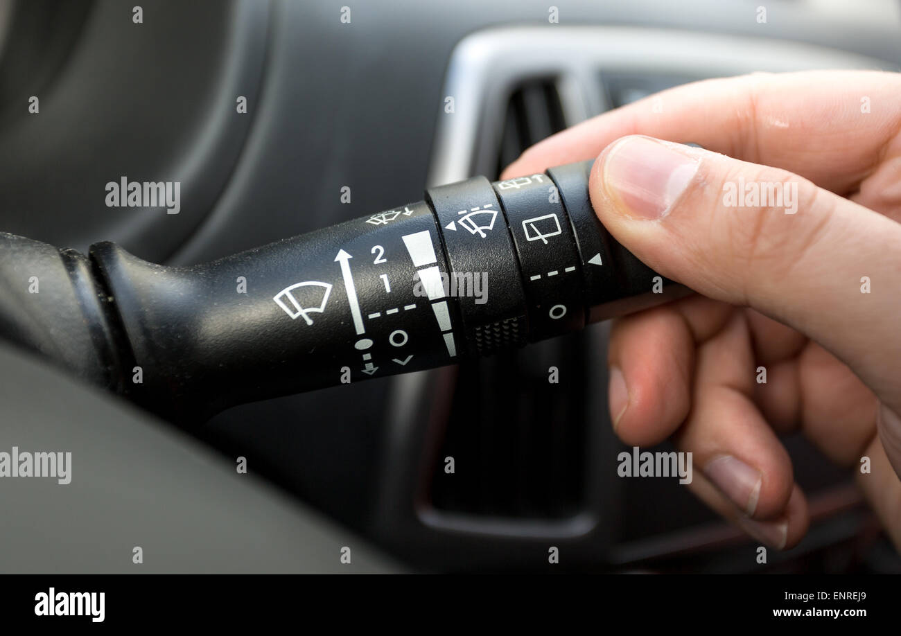 Macro photo of driver adjusting windscreen wipers control toggle Stock ...