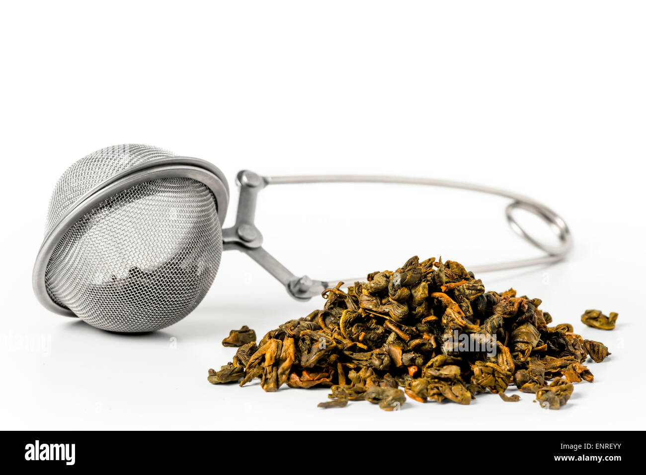 sieve and green tea leaves on a white background Stock Photo - Alamy