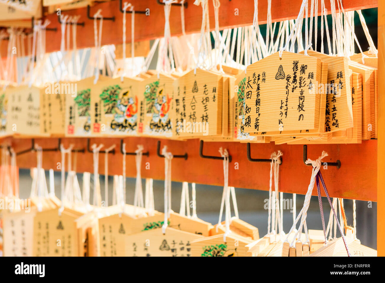Japanese ema boards, wishing tablets, hanging from frame work by red ...