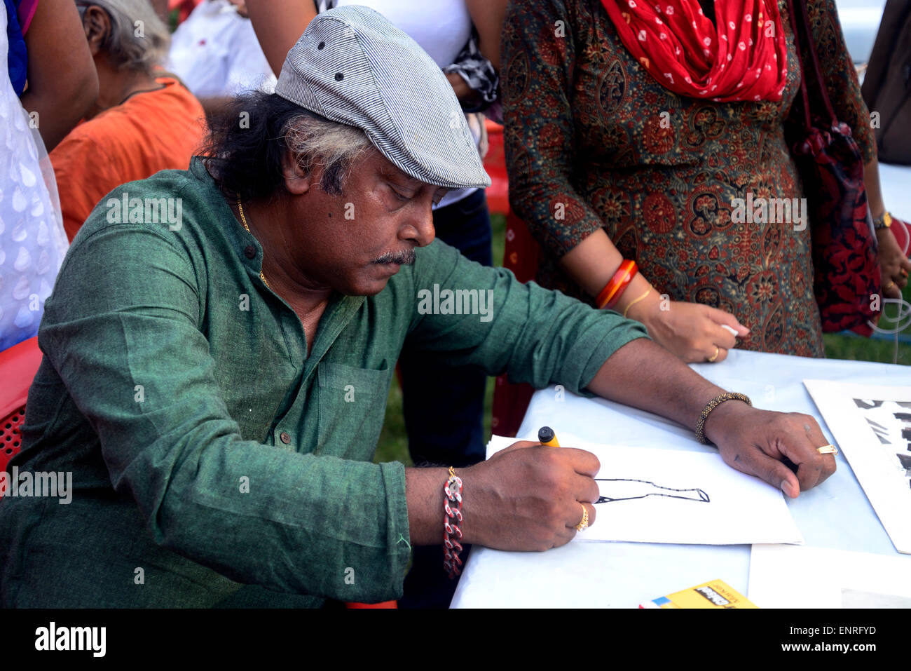 Kolkata, India. 10th May, 2015. Samir Aich drawing a sketch at the ...