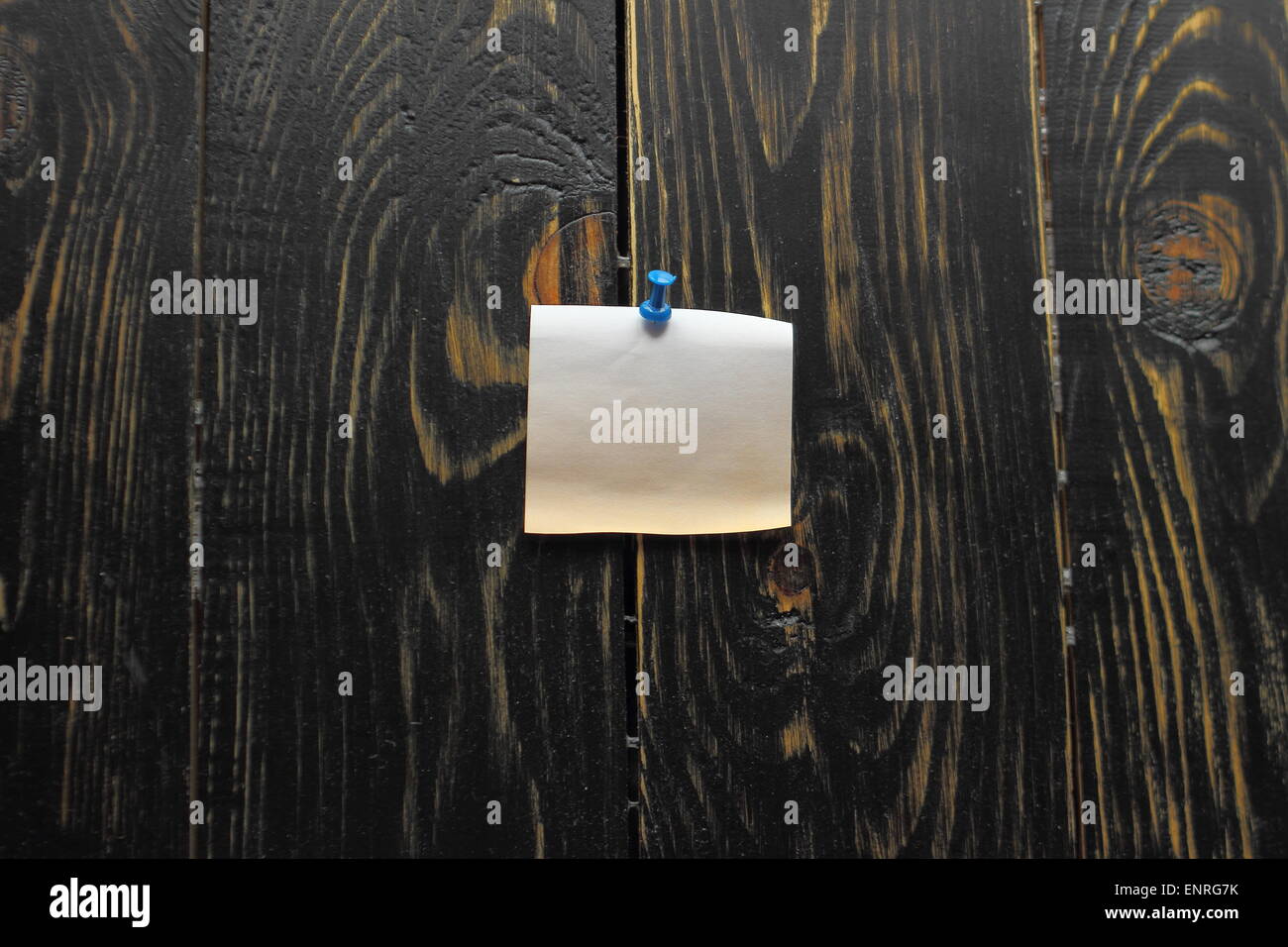 on a wooden board attached to a small piece of paper Stock Photo - Alamy