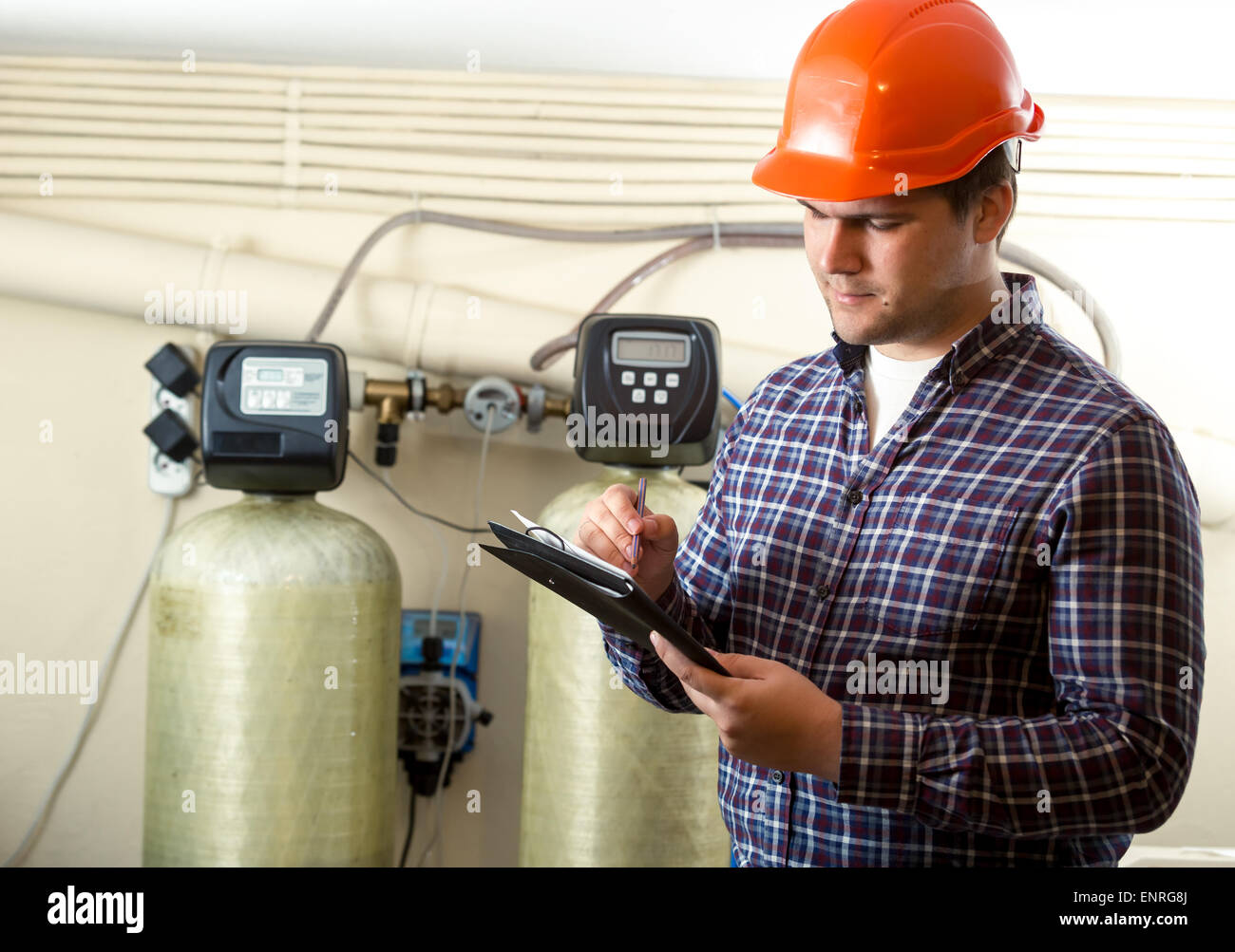 Portrait of inspector checking work of factory equipment Stock Photo ...