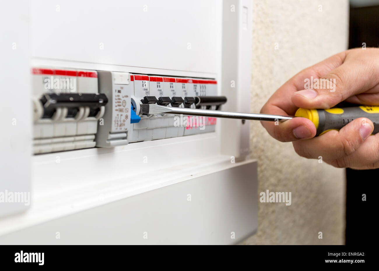 Closeup shot of electrician installing fuse in dashboard with ...