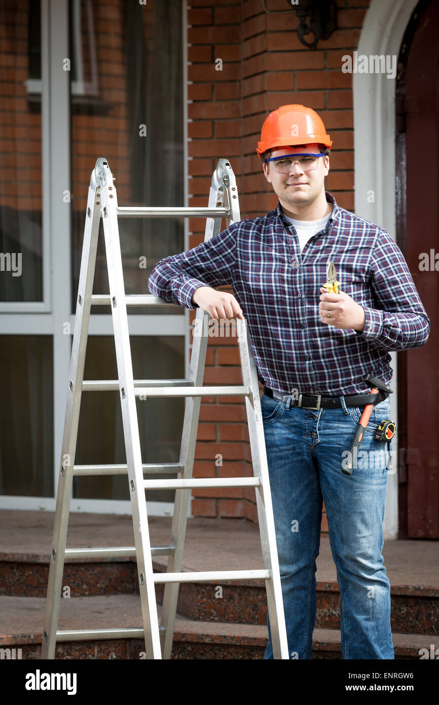Portrait of happy worker on building site holding thumbs up Stock Photo ...