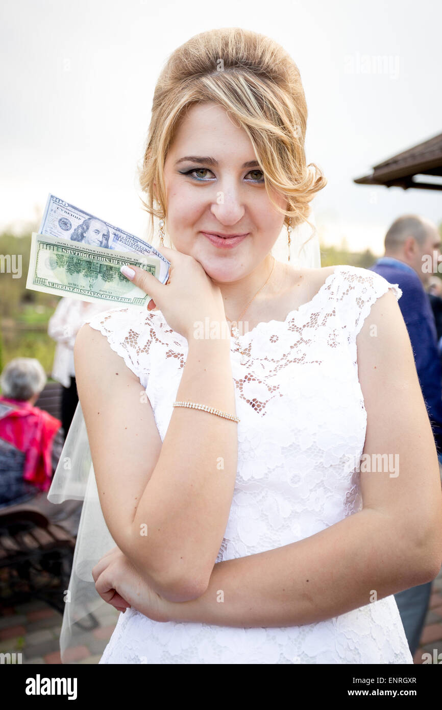 Closeup portrait of beautiful bride holding pack of money Stock Photo ...