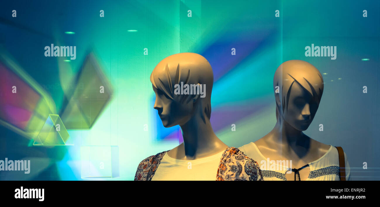 Mannequins in clothes store window Stock Photo - Alamy