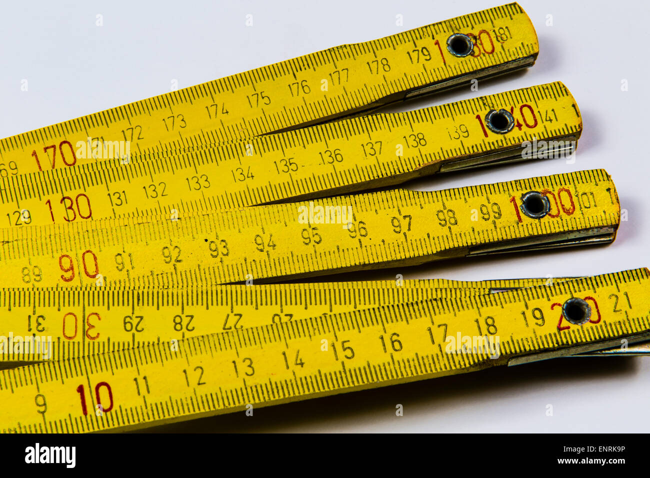 Yellow wooden folding ruler on white background Stock Photo - Alamy