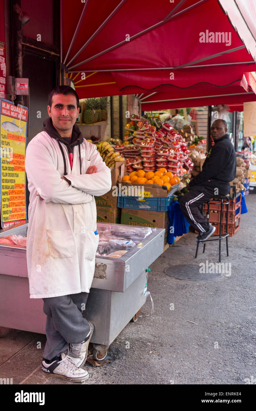 Two shopkeepers outside their traditional food shops on Electric Avenue ...