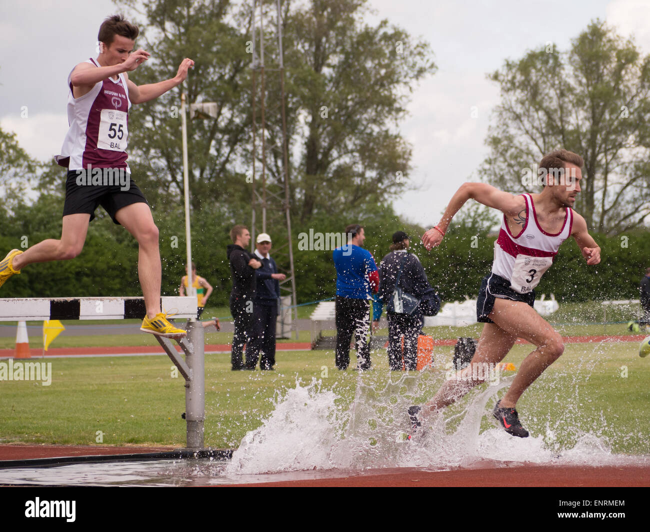 Athletes take on the water jump during a steeplechase race Stock Photo ...