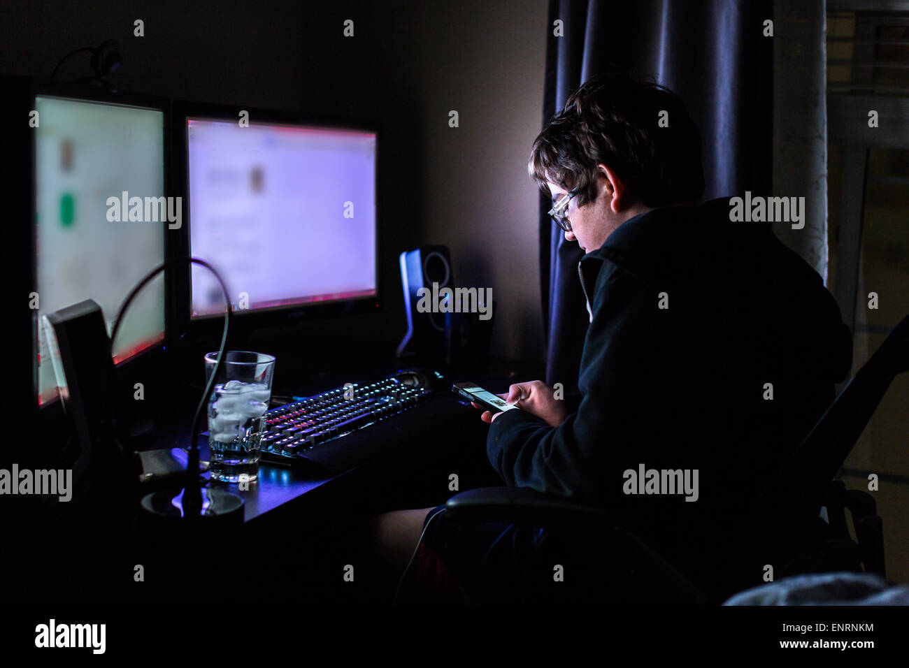 Teenager boy on computer in his room late at night Stock Photo - Alamy