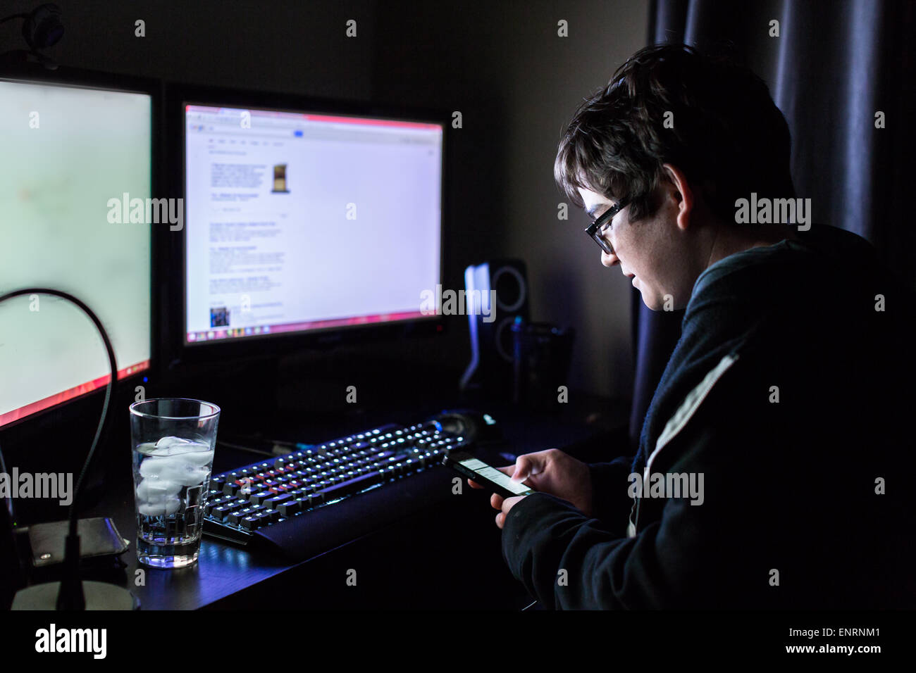 Teenager boy on computer in his room late at night Stock Photo - Alamy