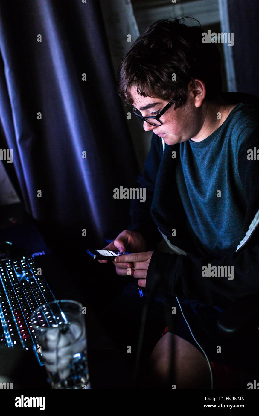 Teenager boy on computer in his room late at night Stock Photo - Alamy