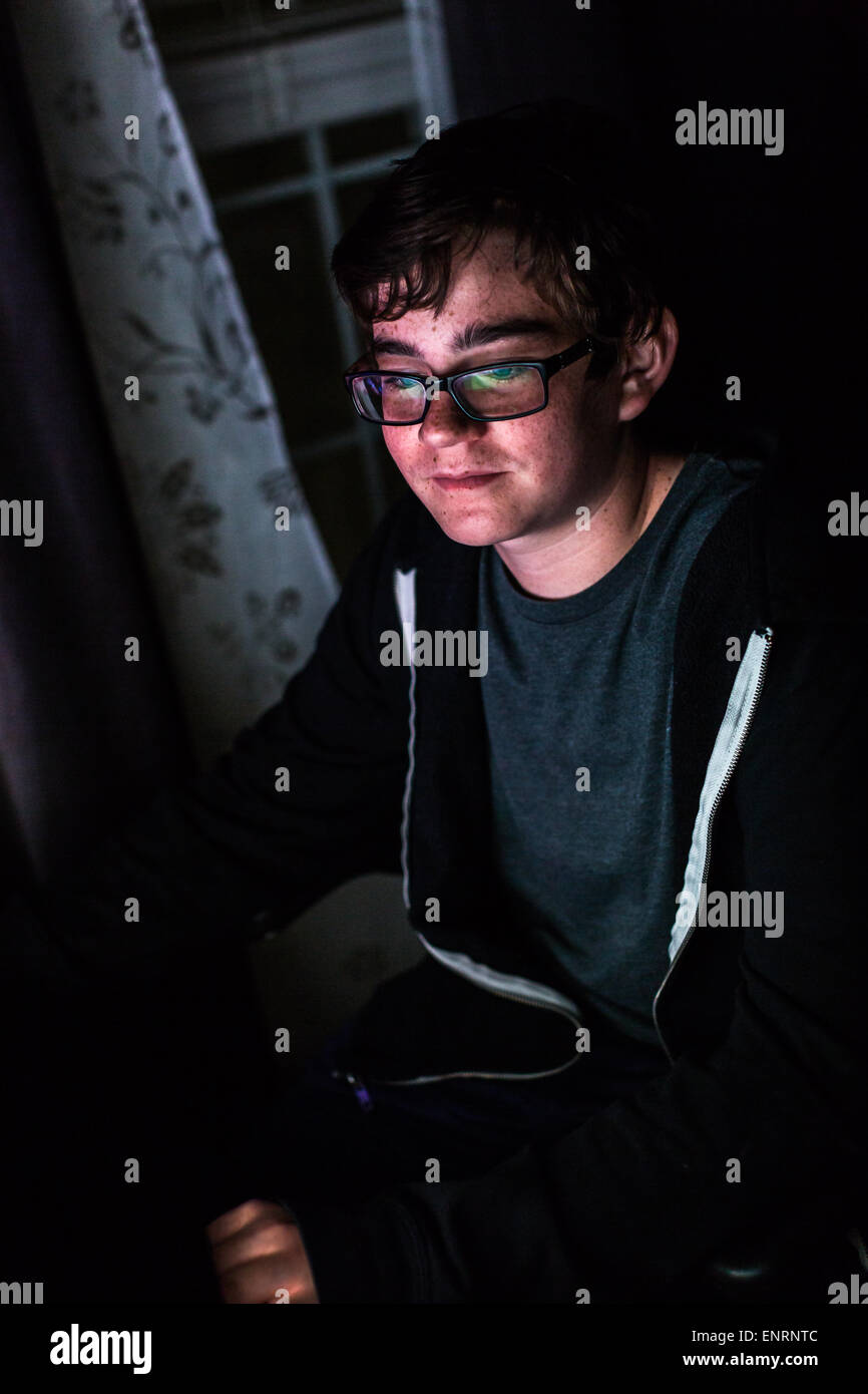 Teenager boy on computer in his room late at night Stock Photo - Alamy