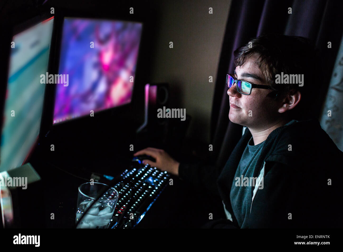 Teenager boy on computer in his room late at night Stock Photo - Alamy