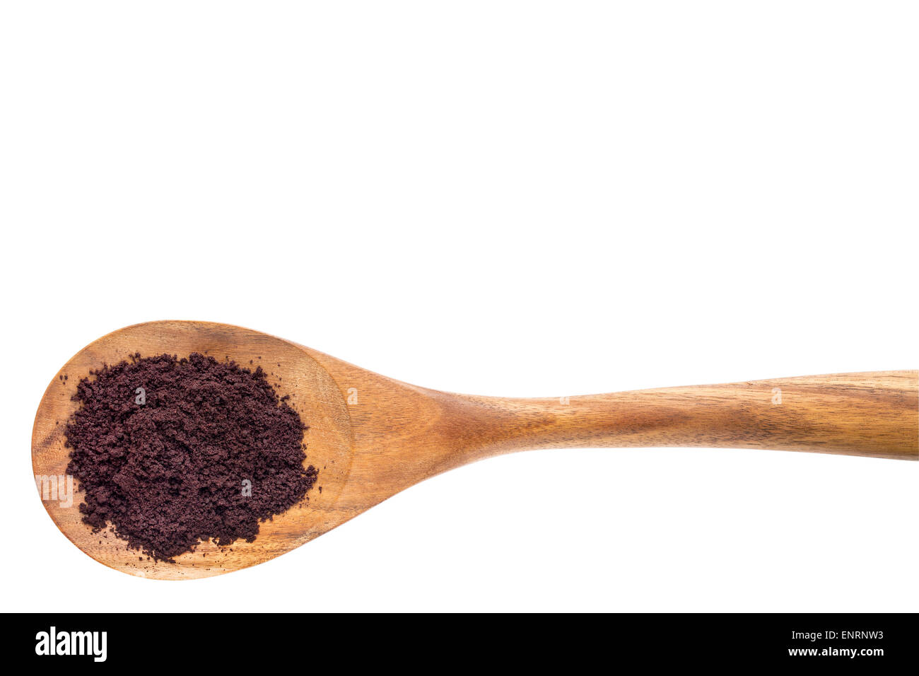 acai berry powder on a wooden spoon isolated on white with a clipping ...