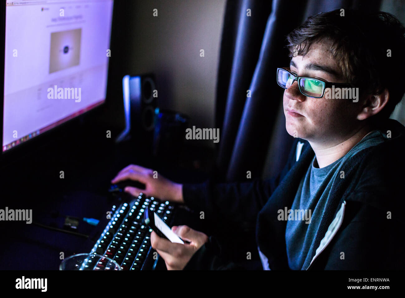 Teenager boy on computer in his room late at night Stock Photo - Alamy