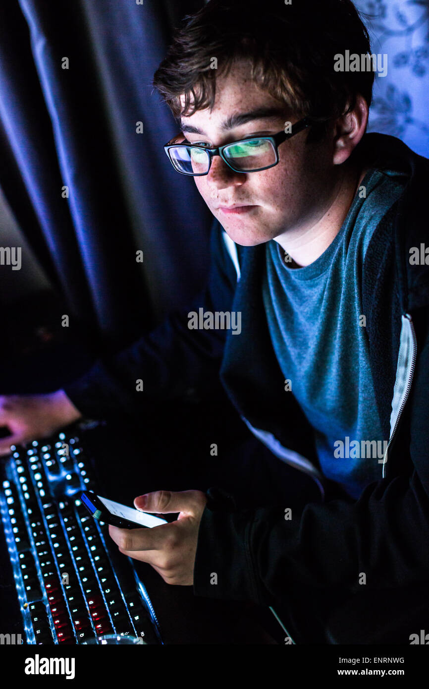 Teenager boy on computer in his room late at night Stock Photo - Alamy