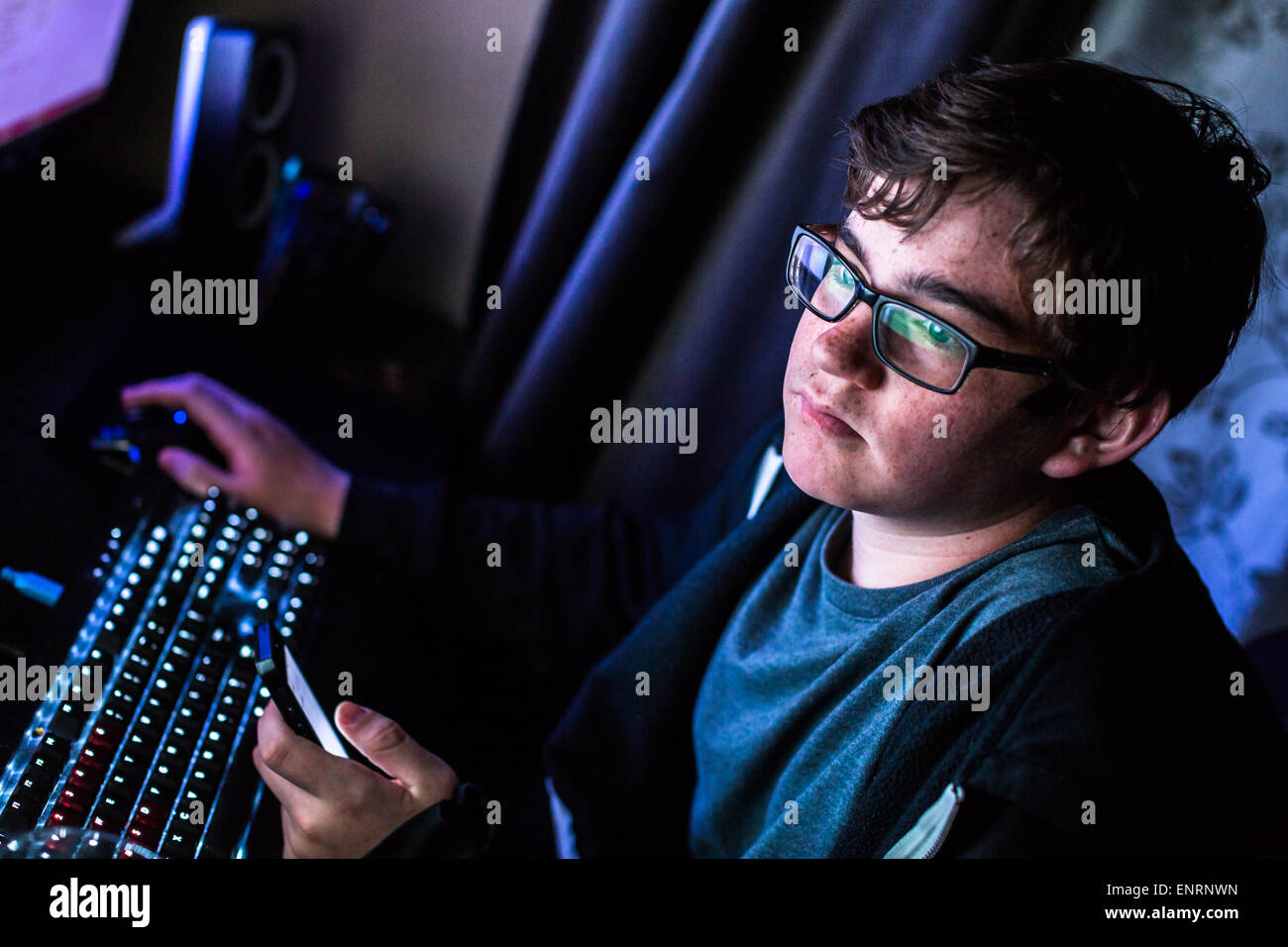 Teenager boy on computer in his room late at night Stock Photo - Alamy